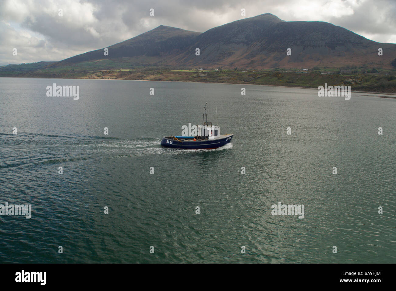 Fishing boat returning to harbor near Trefor Pier, North Wales Stock ...