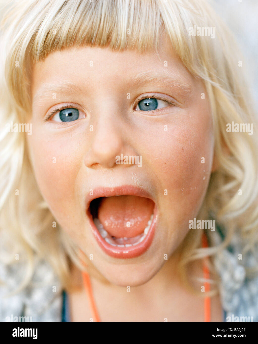 Portrait of a girl with her mouth open, Sweden Stock Photo - Alamy