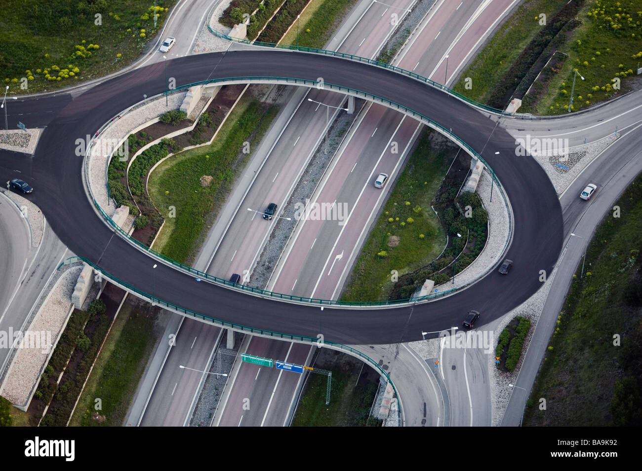 A roundabout above a motorway Stock Photo - Alamy