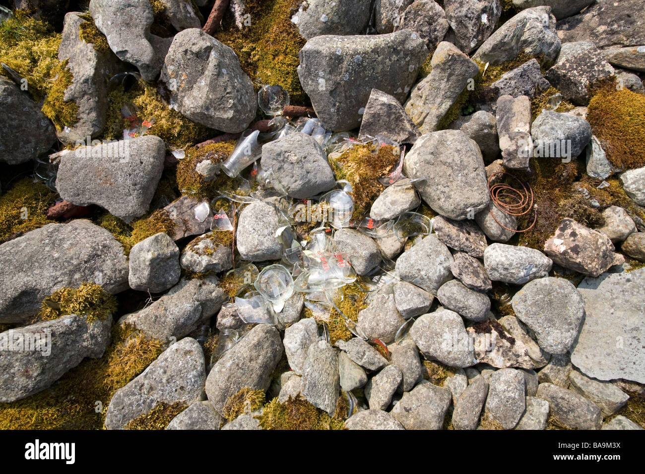 Old rusty metal springs and broken glass dumped on fragments of ...