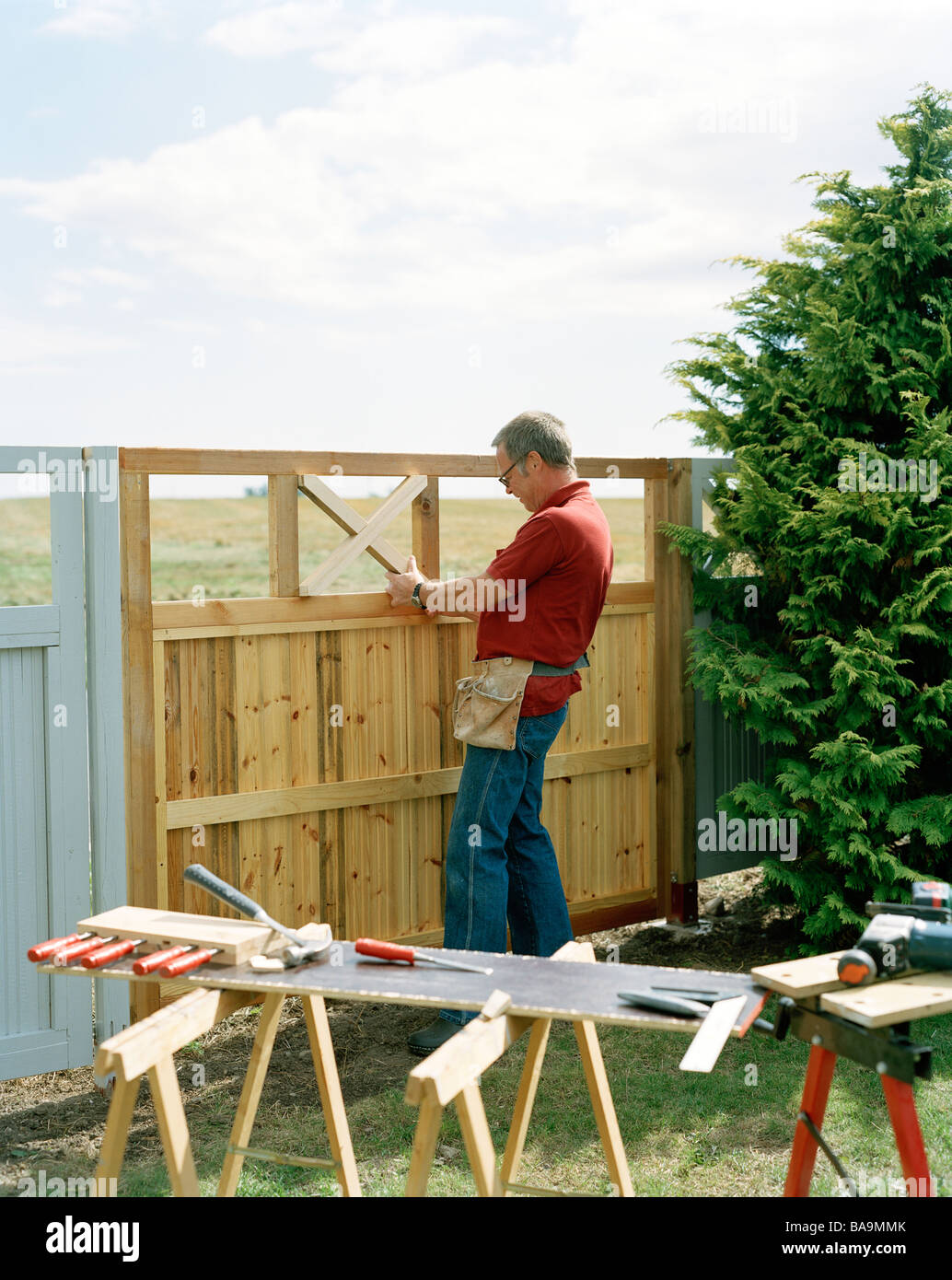 Man building a fence in a garden hi-res stock photography and images ...