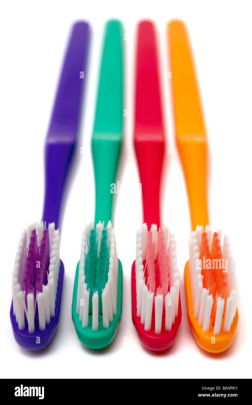 Four mixed coloured toothbrushes Stock Photo - Alamy