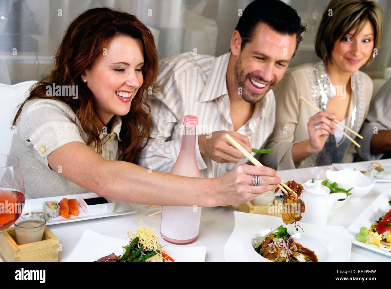 Group of attractive people eating and socializing at a restaurant Stock ...