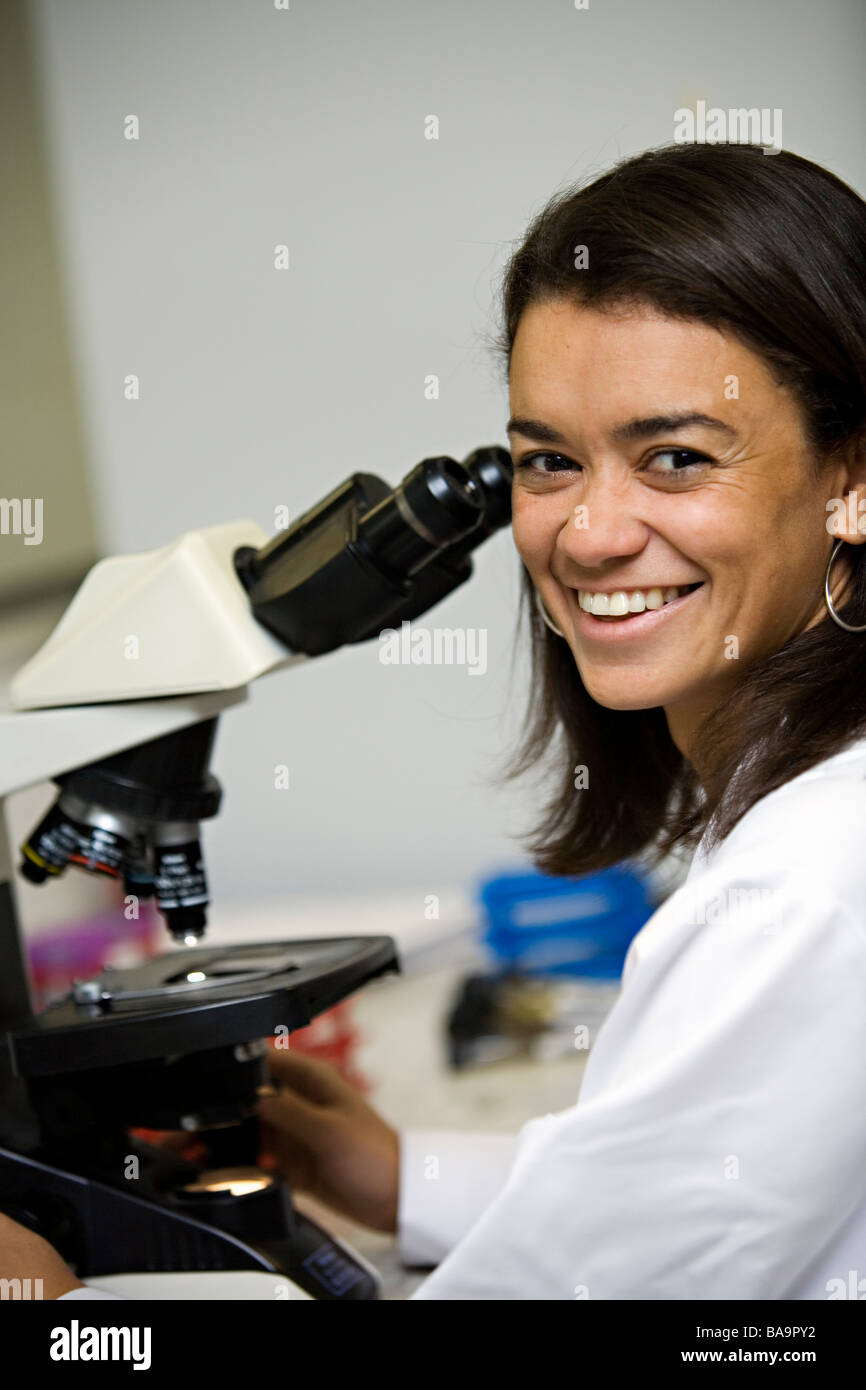 Smiling woman with a microscope, Brazil Stock Photo - Alamy