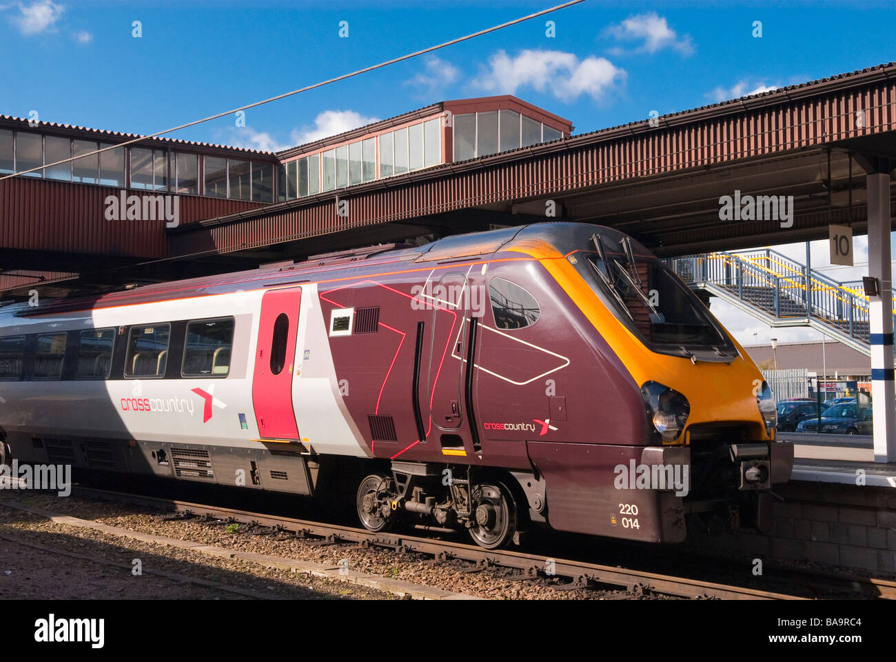 A train waiting at an outside platform at York Station in York ...