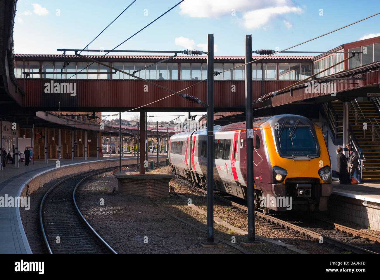A train waiting at an outside platform at York Station in York ...