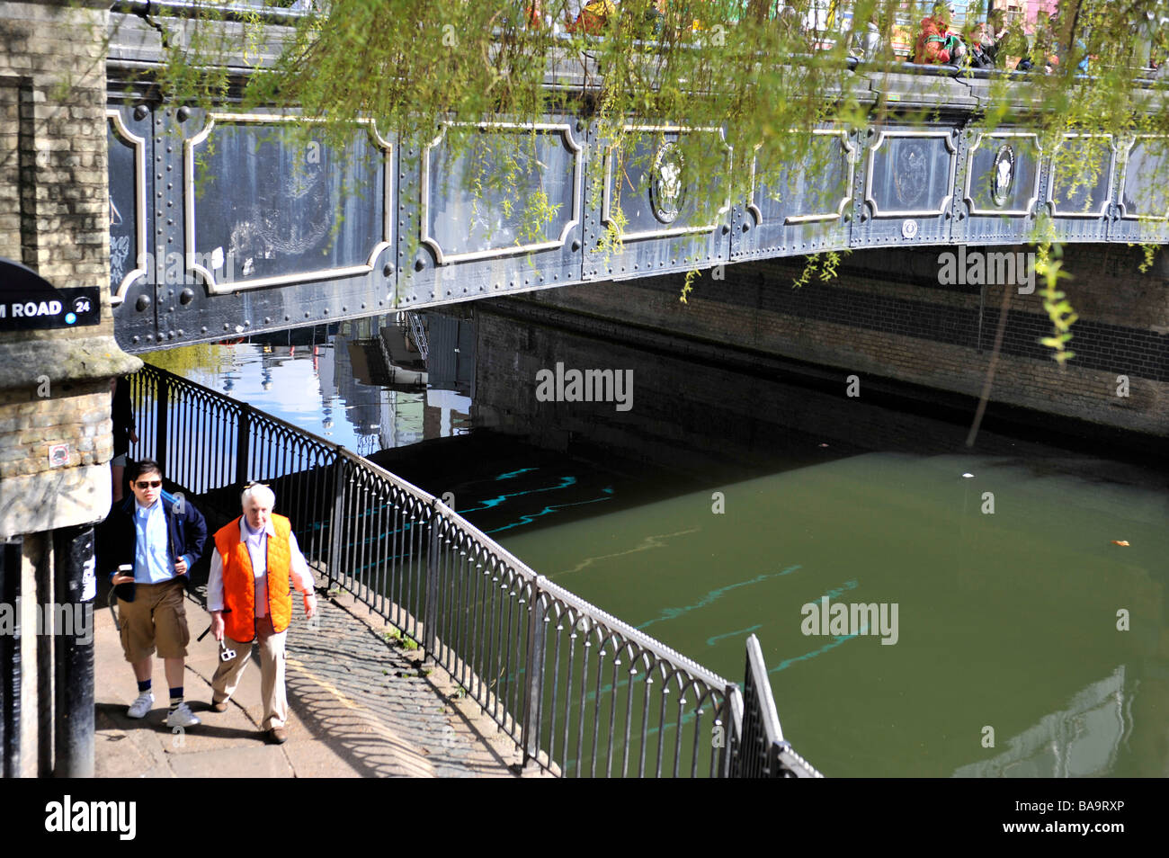 people walking along towpath beside regents canal at camden lock london ...