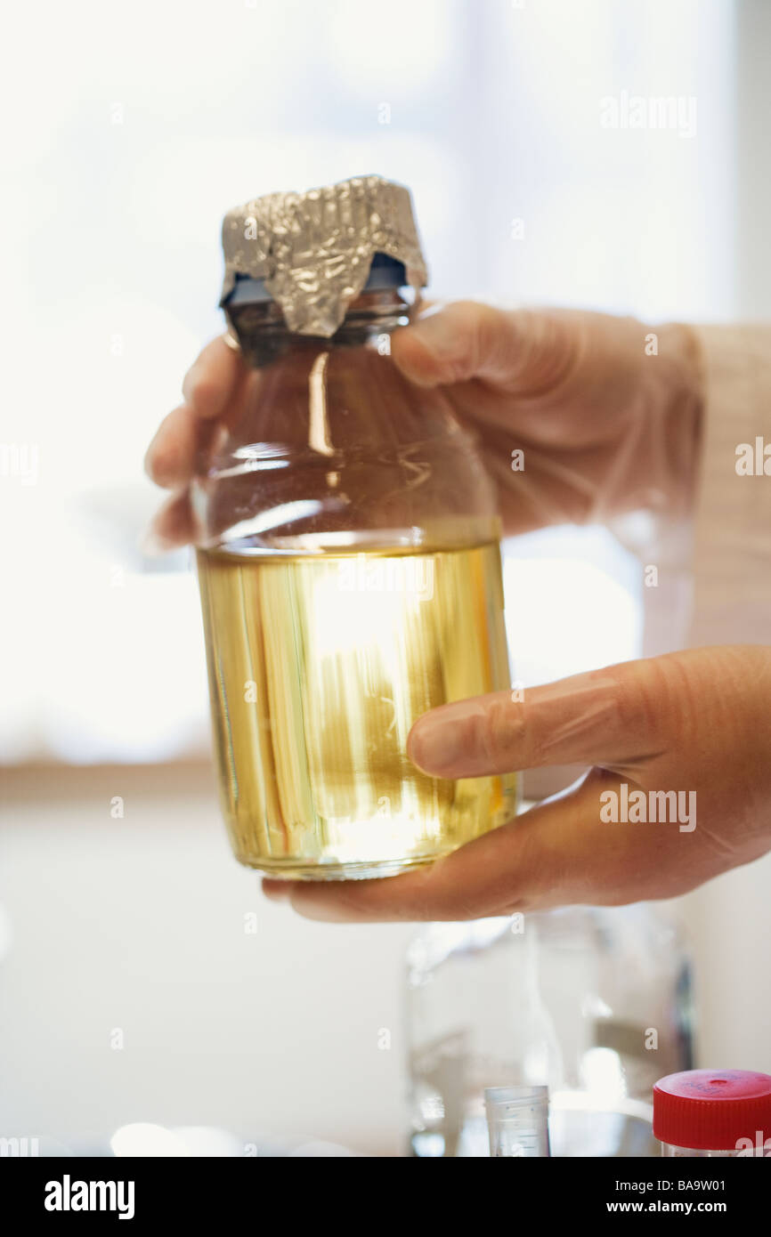 Yellow liquid in a glas container in a laboratory Stock Photo - Alamy