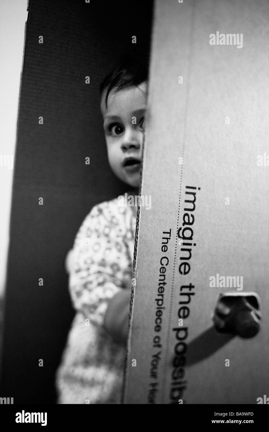 Black child hiding behind Black and White Stock Photos & Images - Alamy