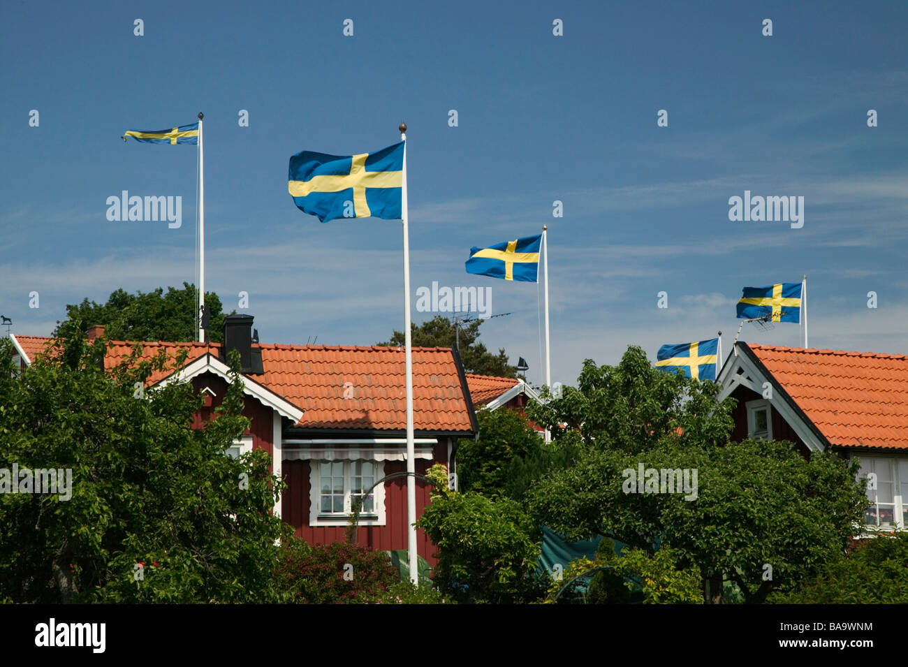 The Swedish flag outside a red cottage Sweden Stock Photo - Alamy