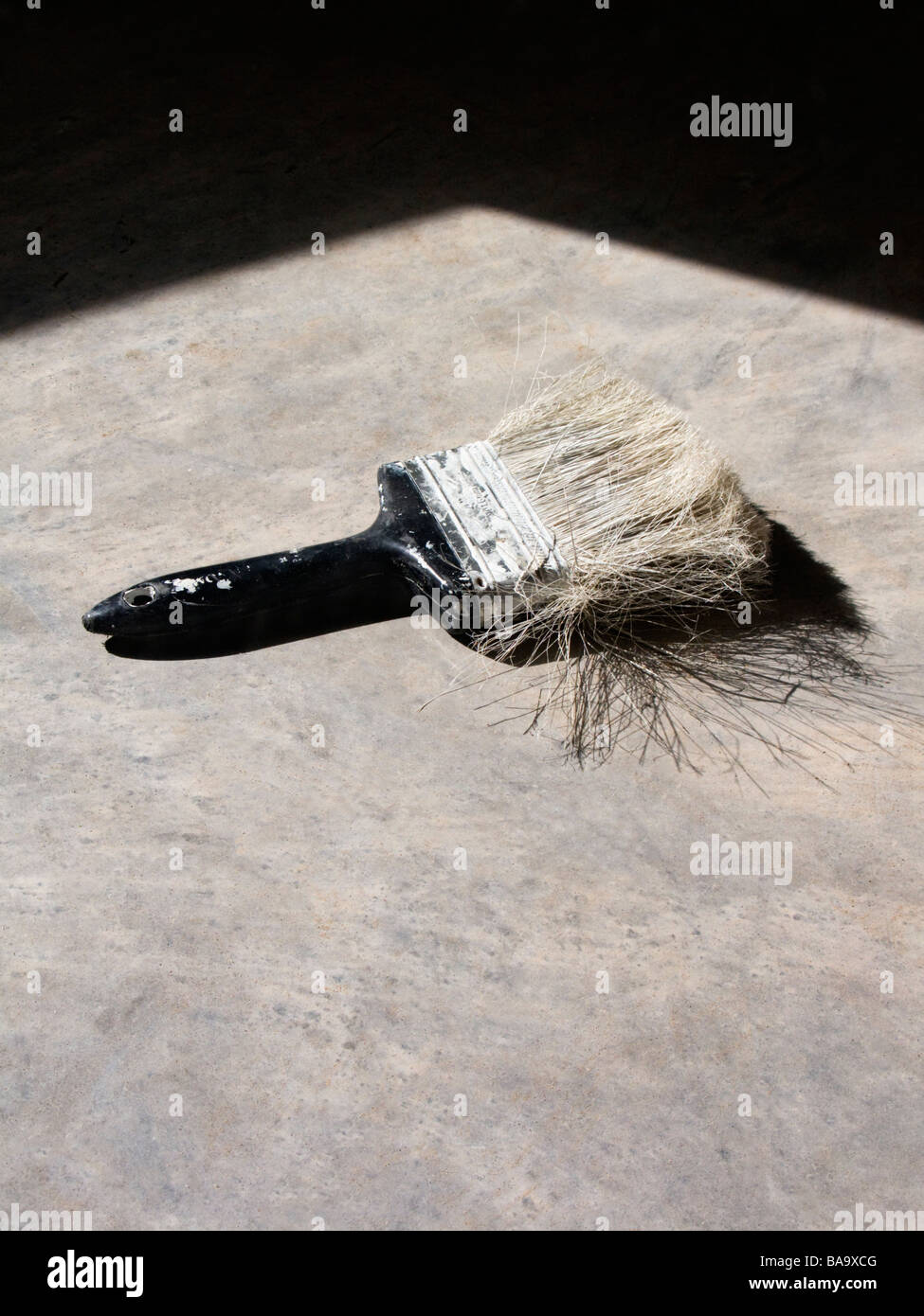 Old paintbrush on concrete floor Stock Photo - Alamy