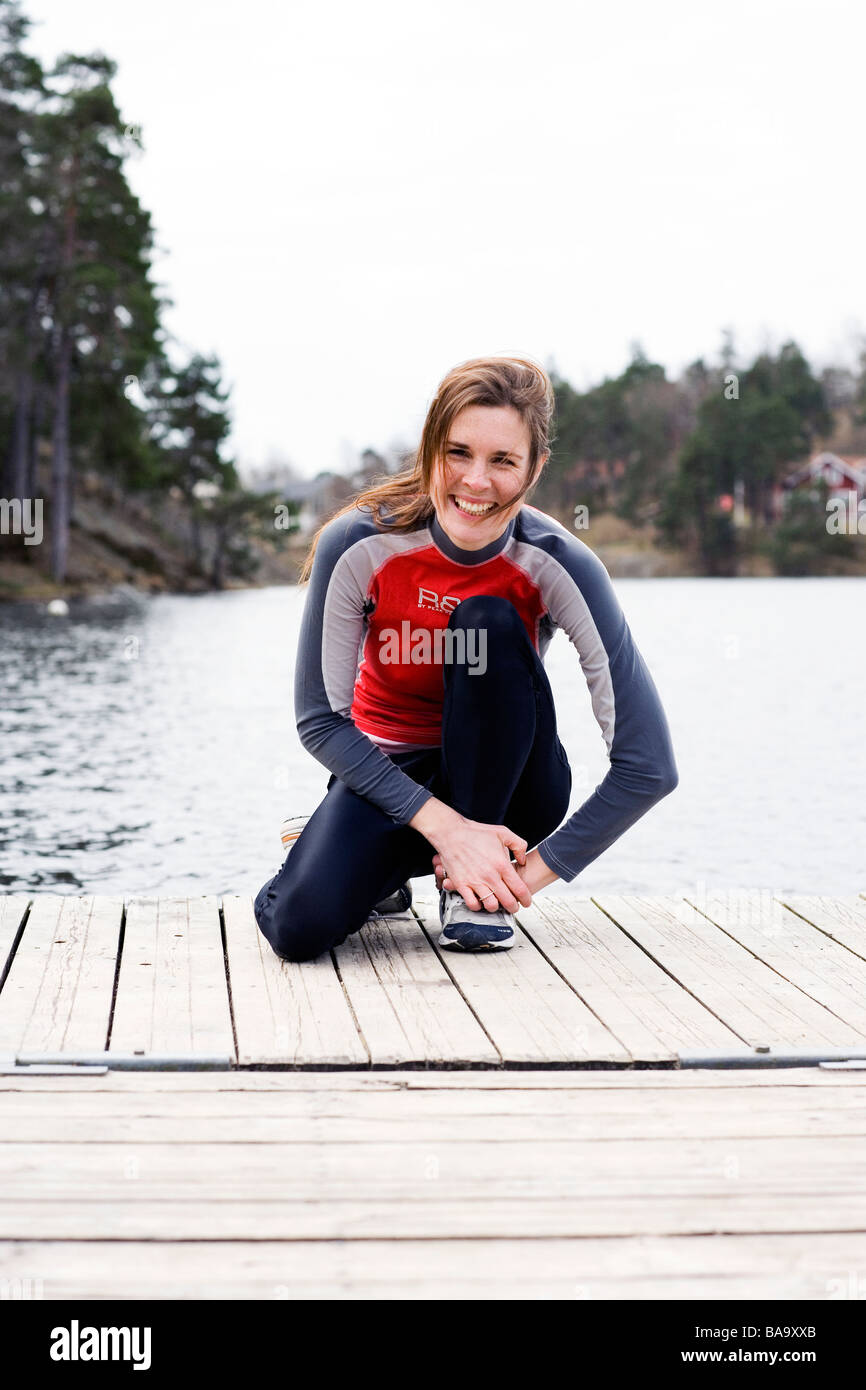 Woman stretching on a jetty, Sweden Stock Photo - Alamy