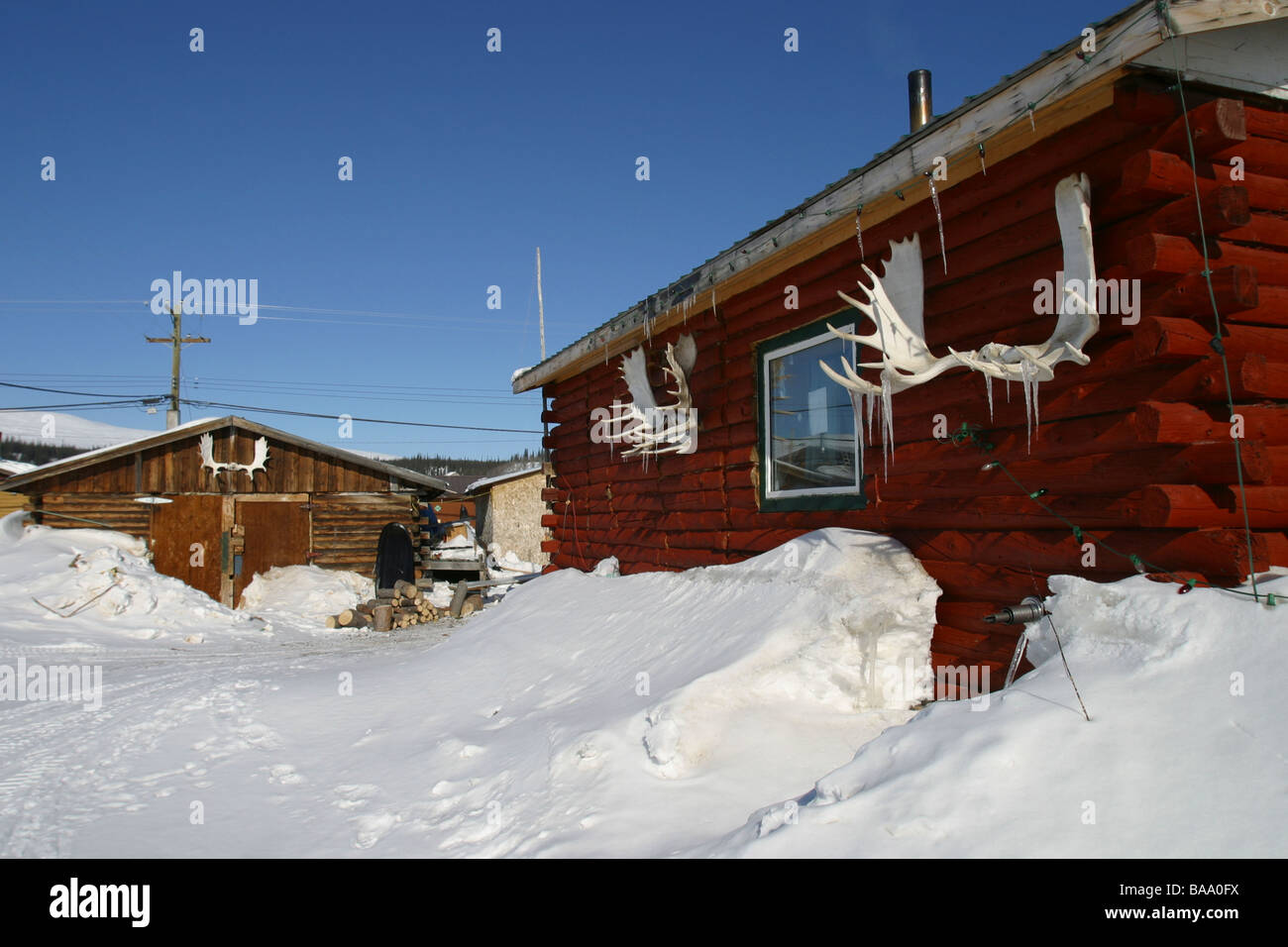 A log house in the snow in the remote fly-in First Nation hamlet of Old ...
