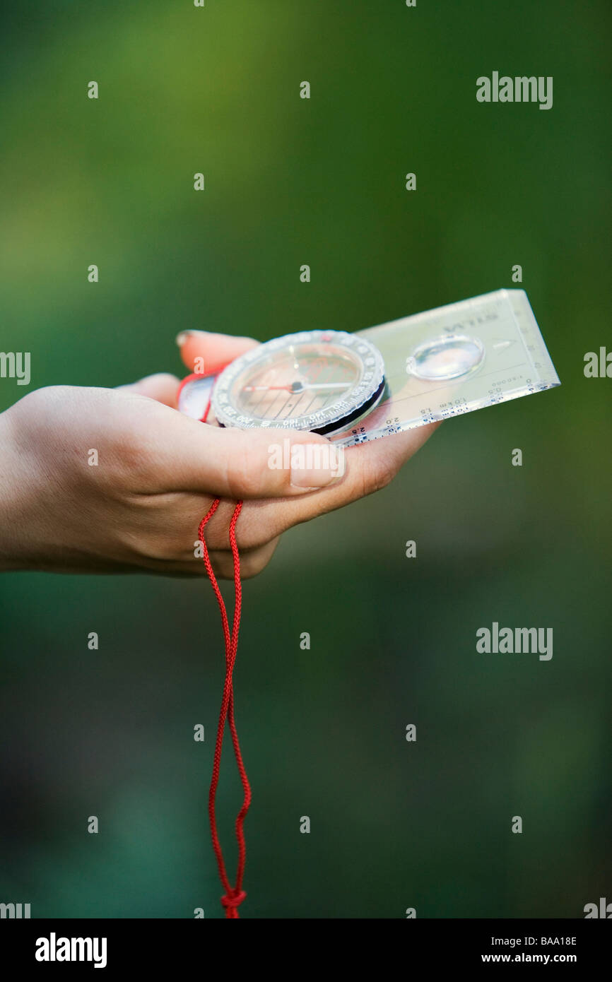 A hand using a compass, Sweden Stock Photo - Alamy