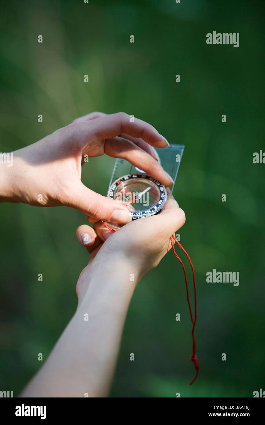 A hand using a compass, Sweden Stock Photo - Alamy