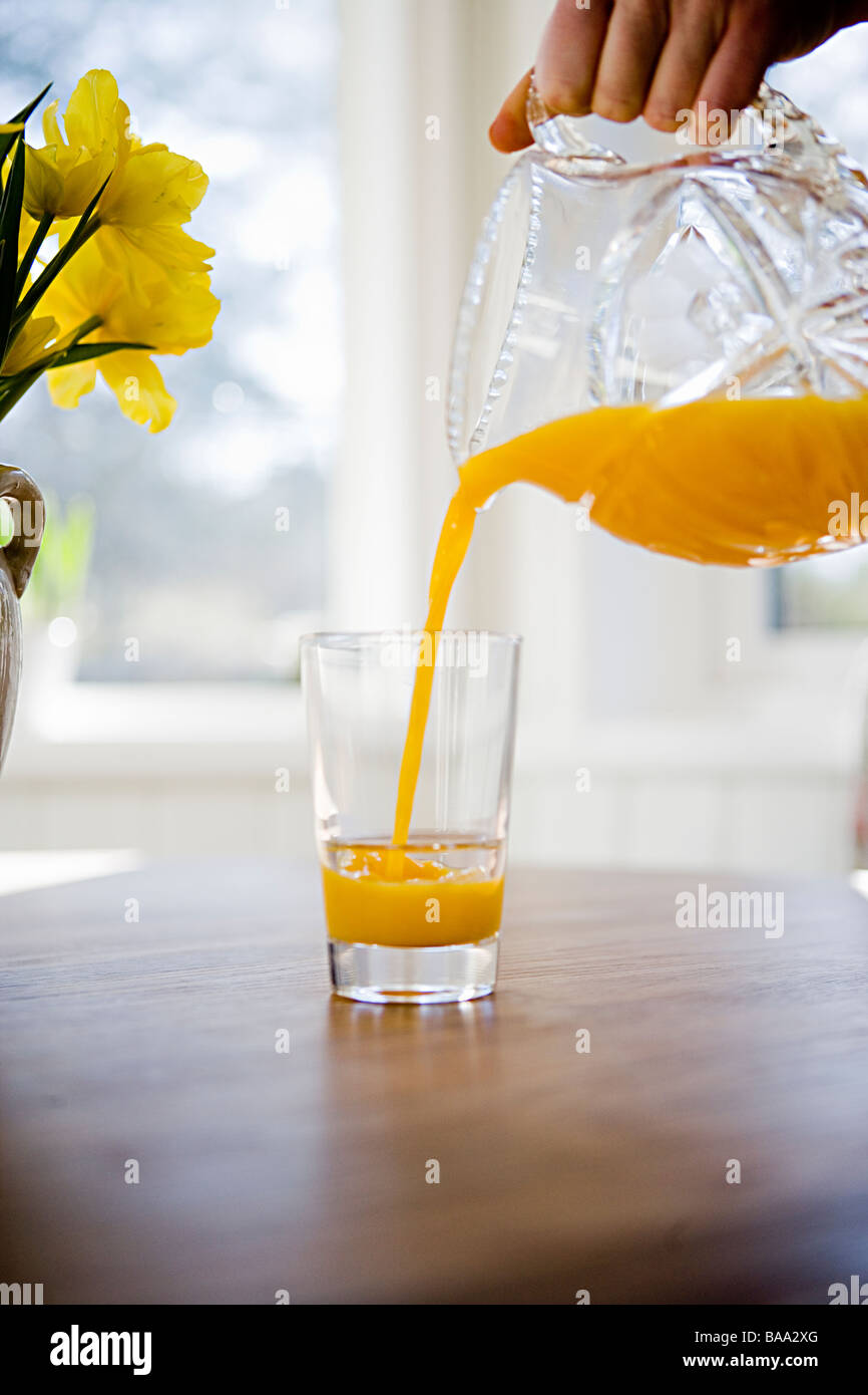 Orange juice is being poured in a glass, Sweden Stock Photo - Alamy