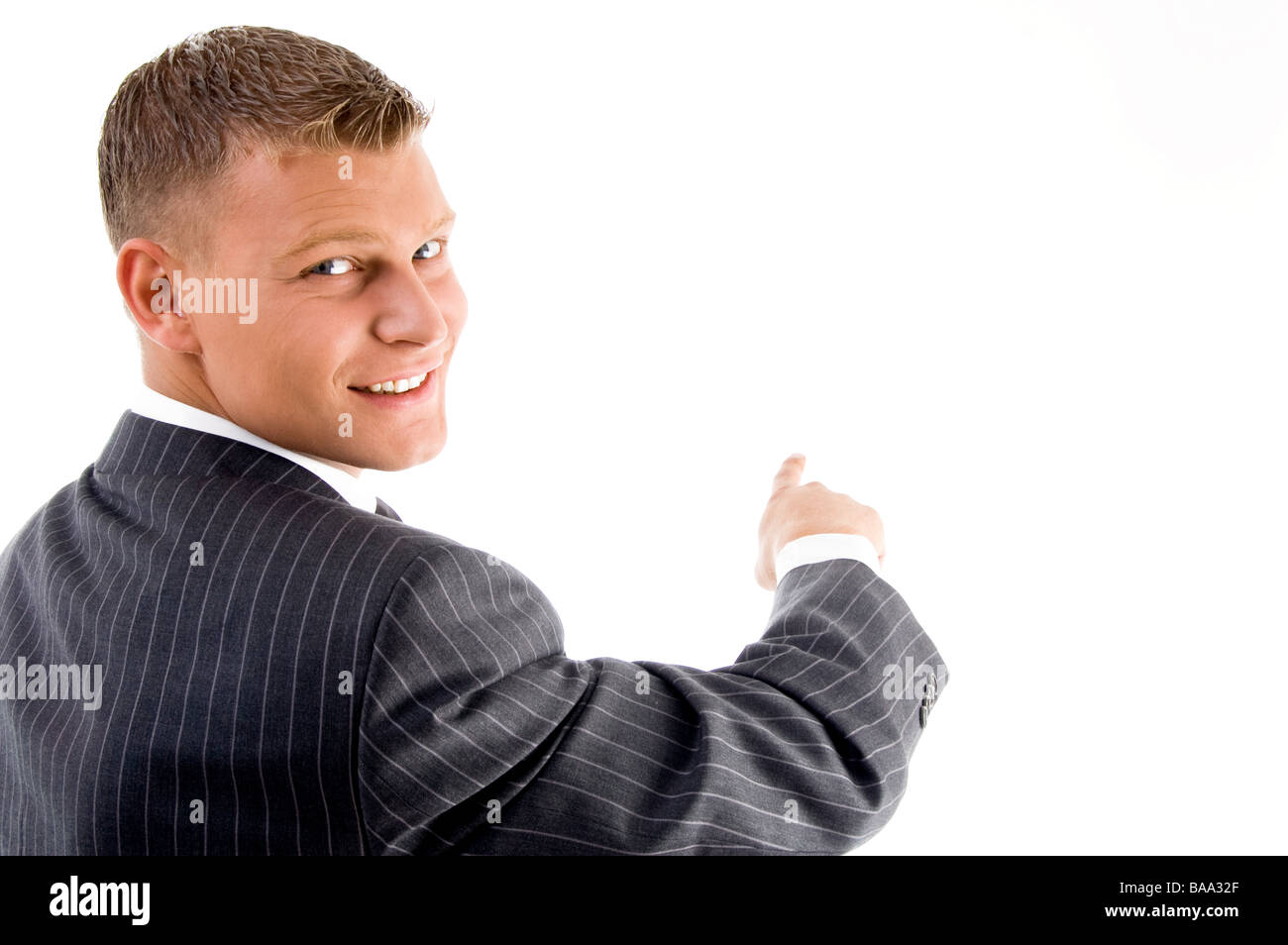 smiling handsome employee pointing back Stock Photo - Alamy