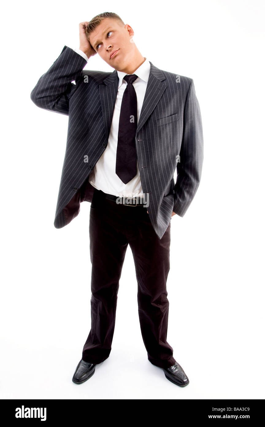 standing young confused businessman Stock Photo - Alamy