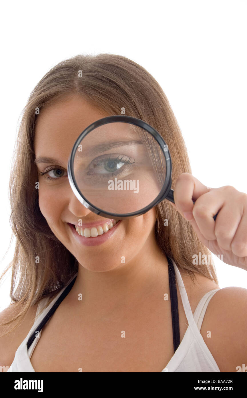 smiling model holding magnifying glass Stock Photo - Alamy