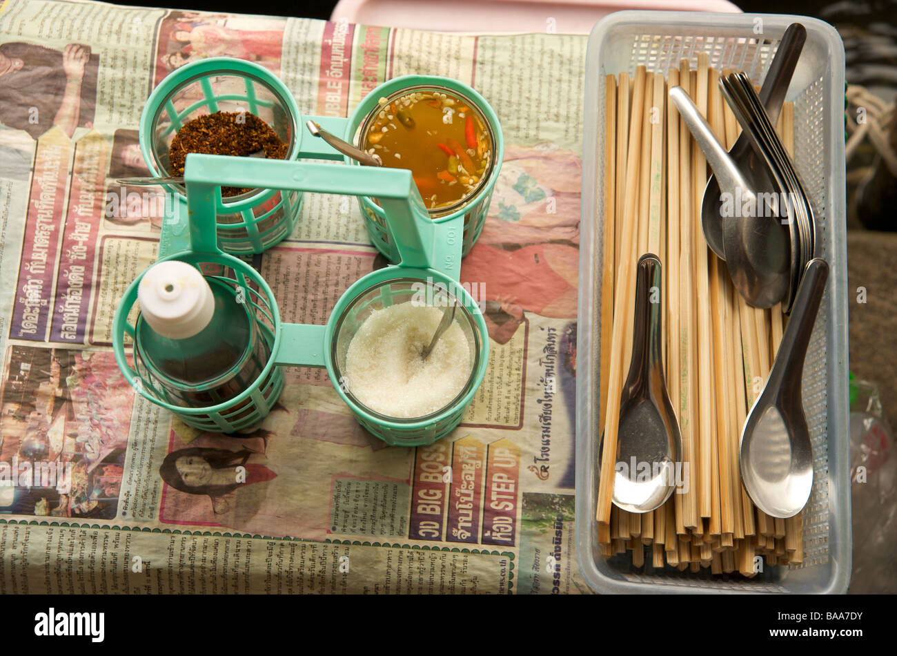 Thai table condiments on a canal side at the floating market near ...