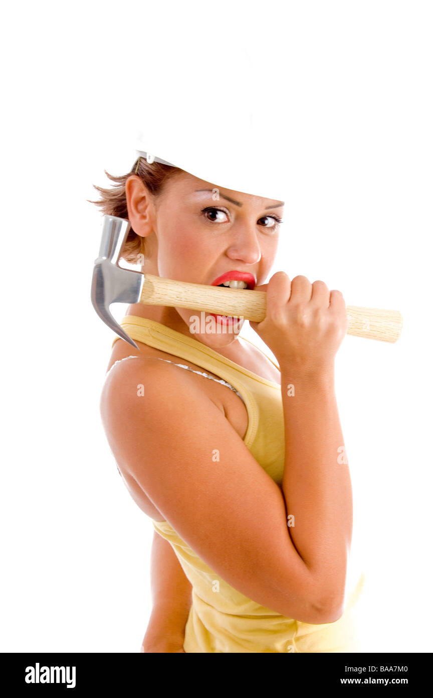 side view of woman holding hammer with mouth Stock Photo - Alamy