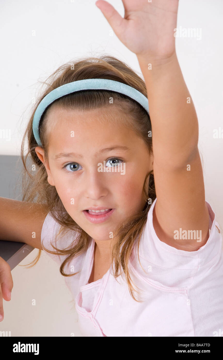 sweet little girl raising her hand Stock Photo - Alamy