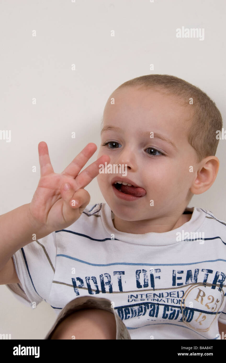 adorable child looking his fingers Stock Photo - Alamy