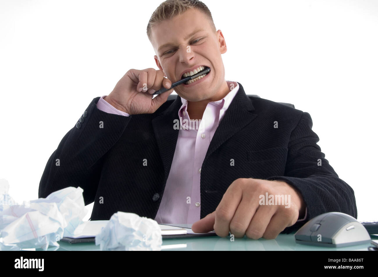 frustrated man biting on pen with teeth Stock Photo - Alamy