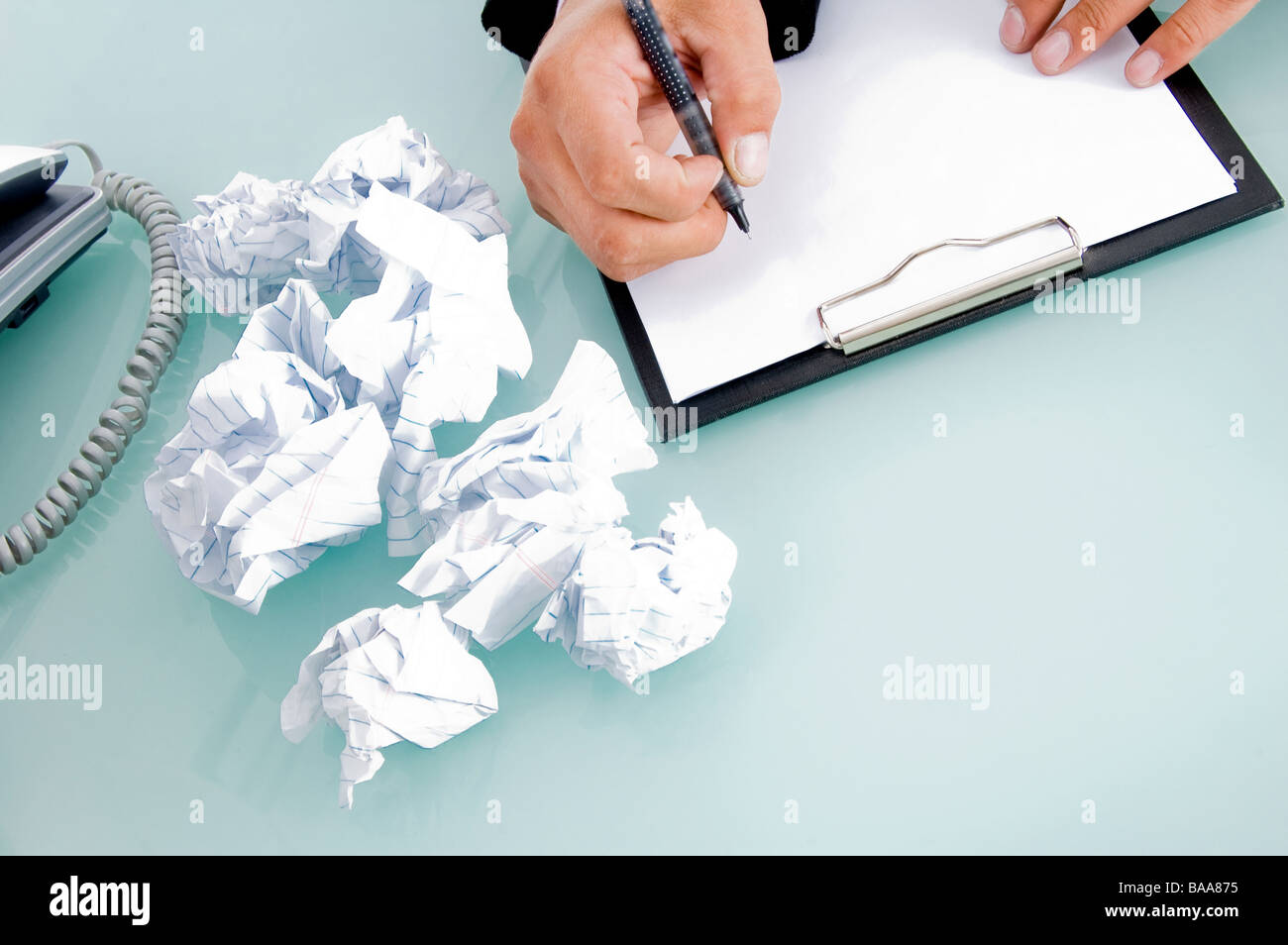 fingers of man with pen writing pad Stock Photo - Alamy