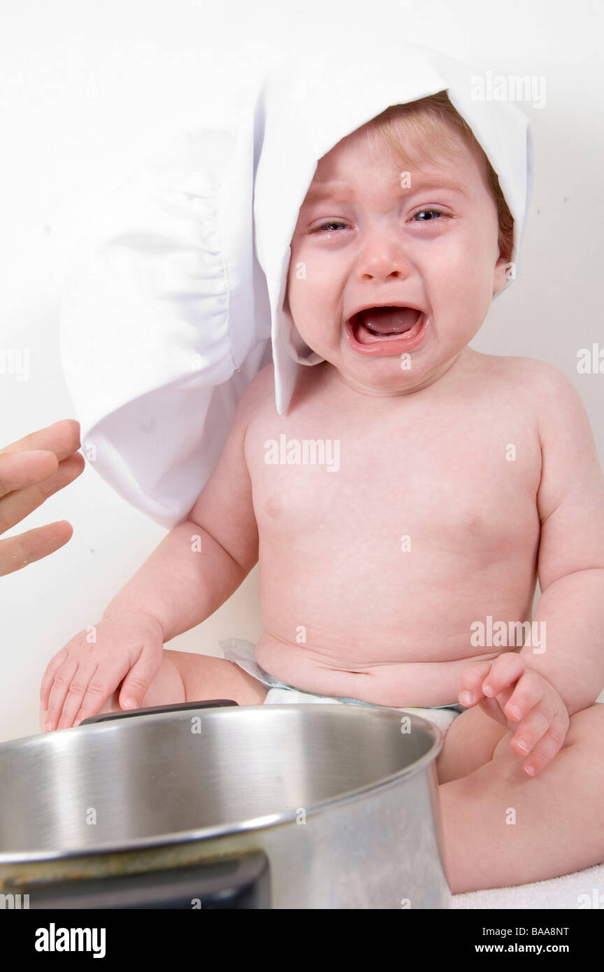 crying baby wearing chef hat and with pan Stock Photo - Alamy