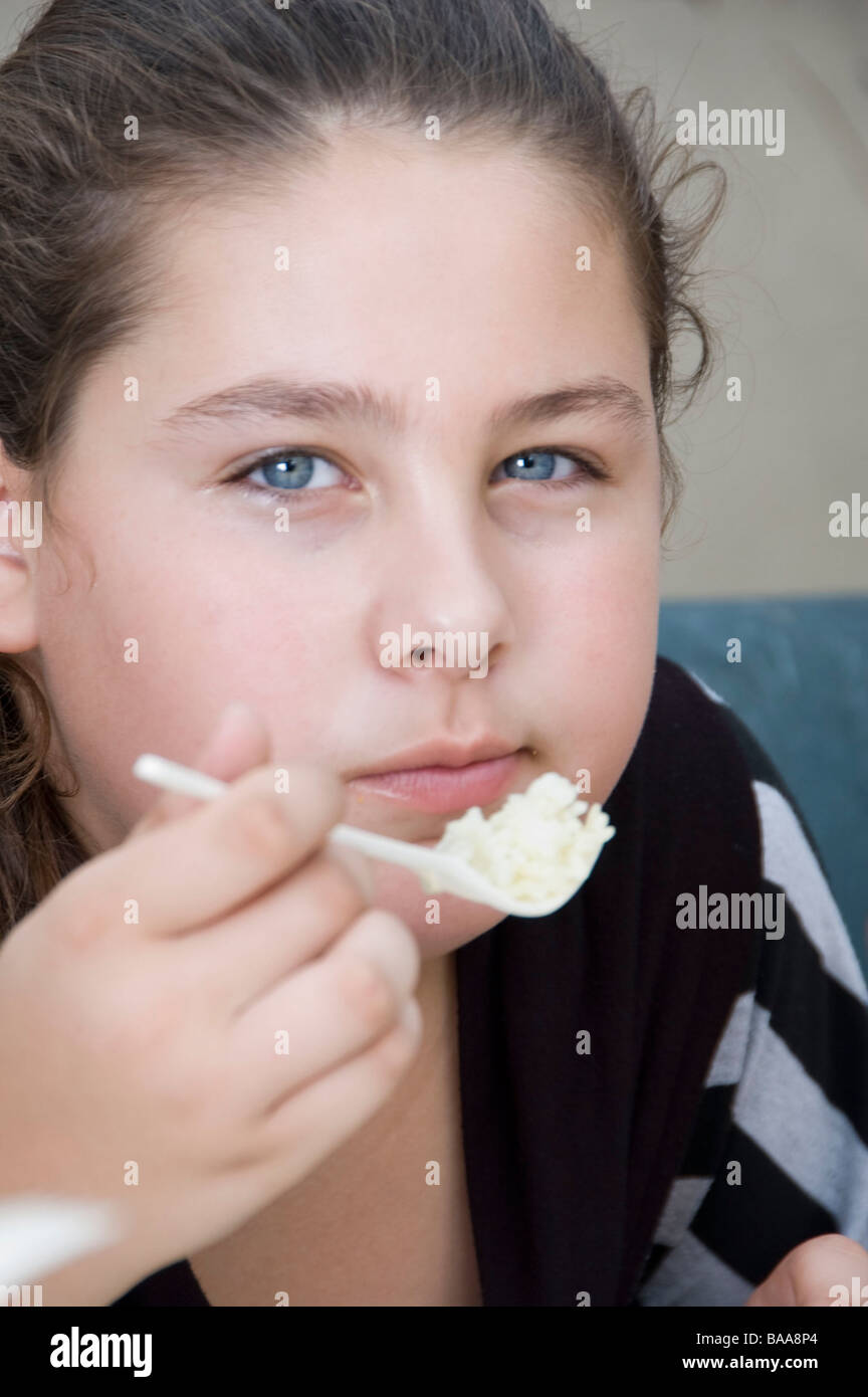 pretty girl eating rice Stock Photo - Alamy