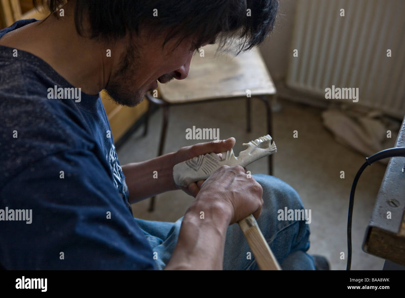 Artists making Tupilaks in Kulusuk Greenland Stock Photo - Alamy