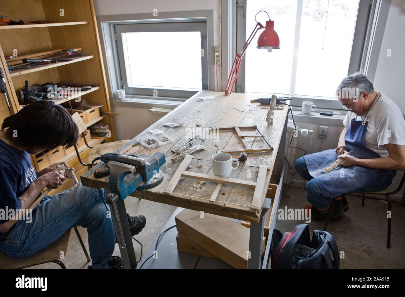 Artists making Tupilaks in Kulusuk Greenland Stock Photo - Alamy