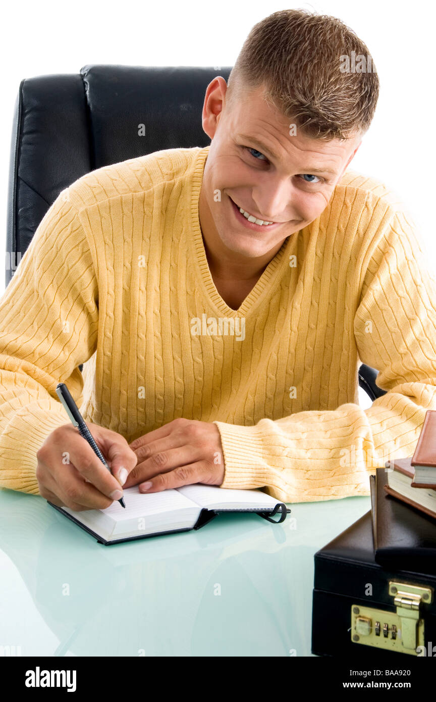 man smiling while writing Stock Photo - Alamy