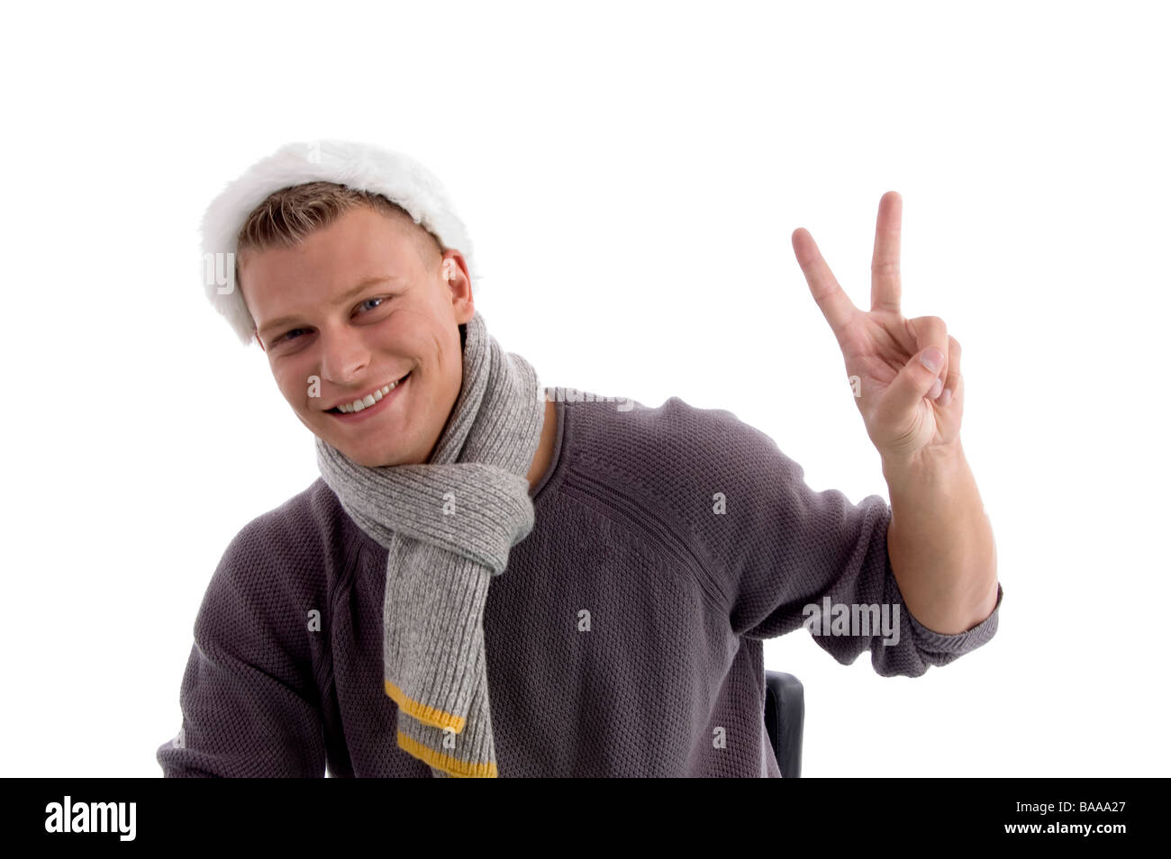 smiling young man with christmas hat showing two fingers Stock Photo ...