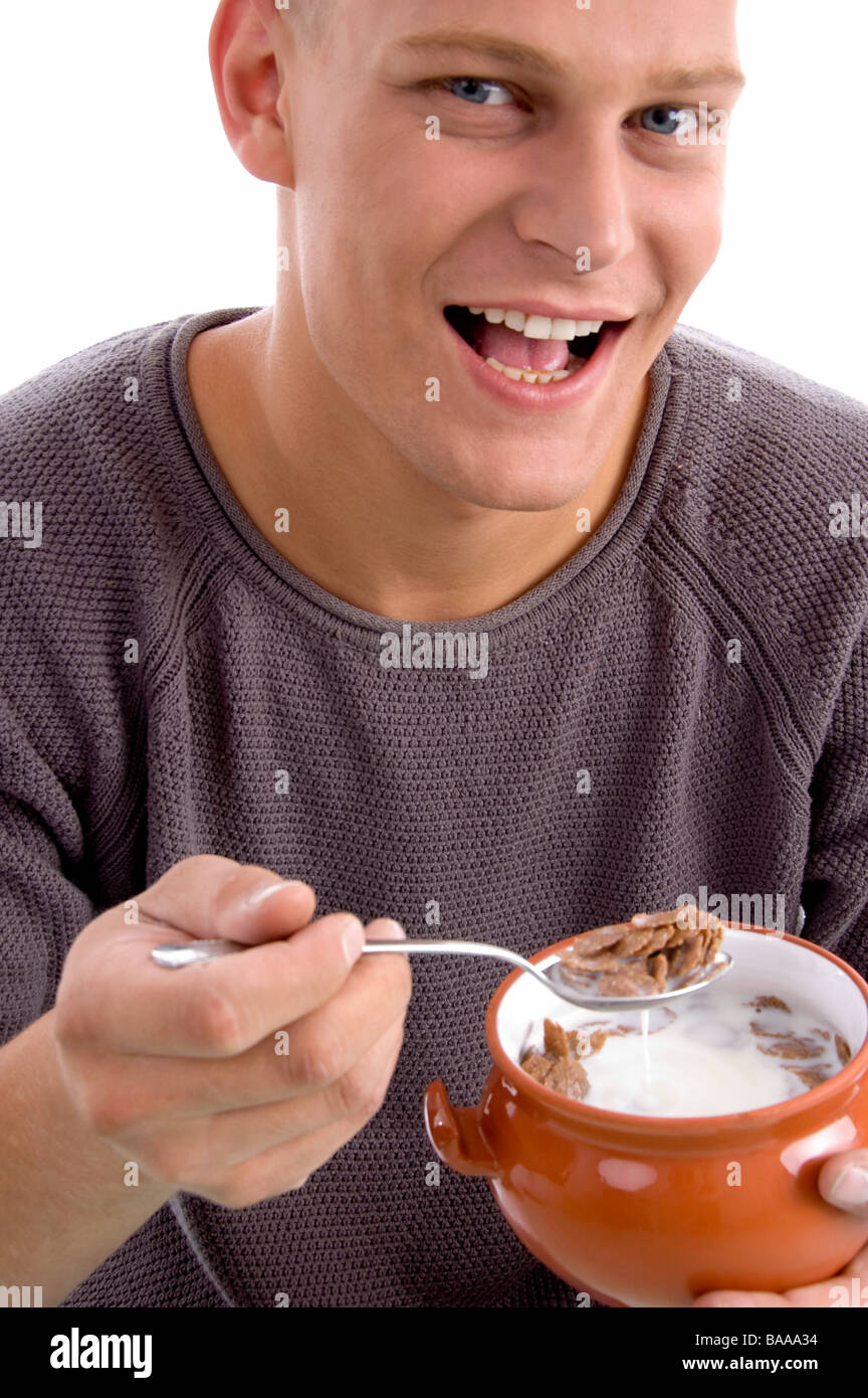 portrait of smiling male eating cornflakes Stock Photo - Alamy