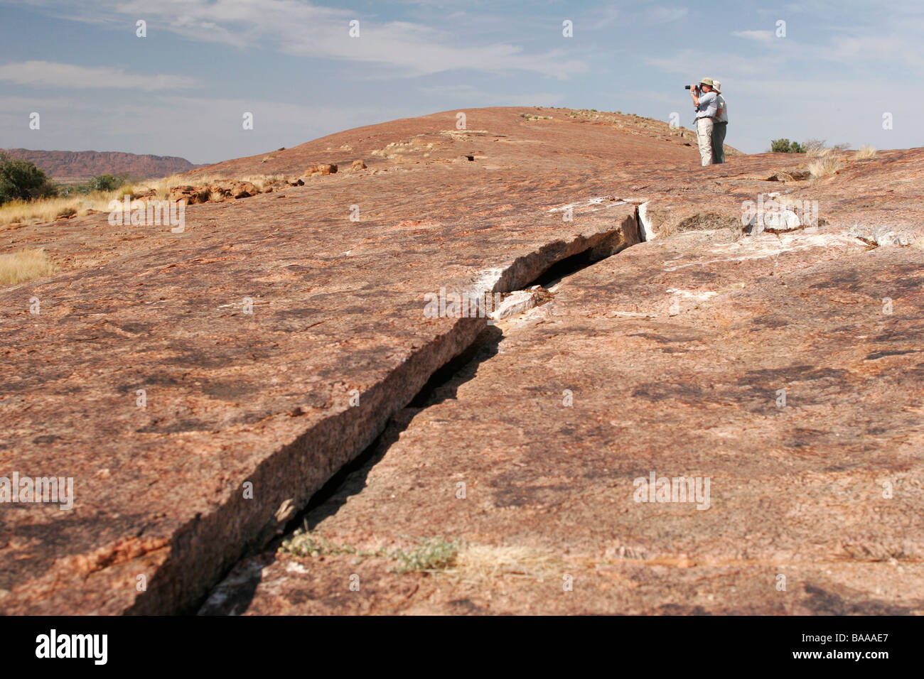 Tourist stand on a naural rock formation known as the Moon Rock in the ...