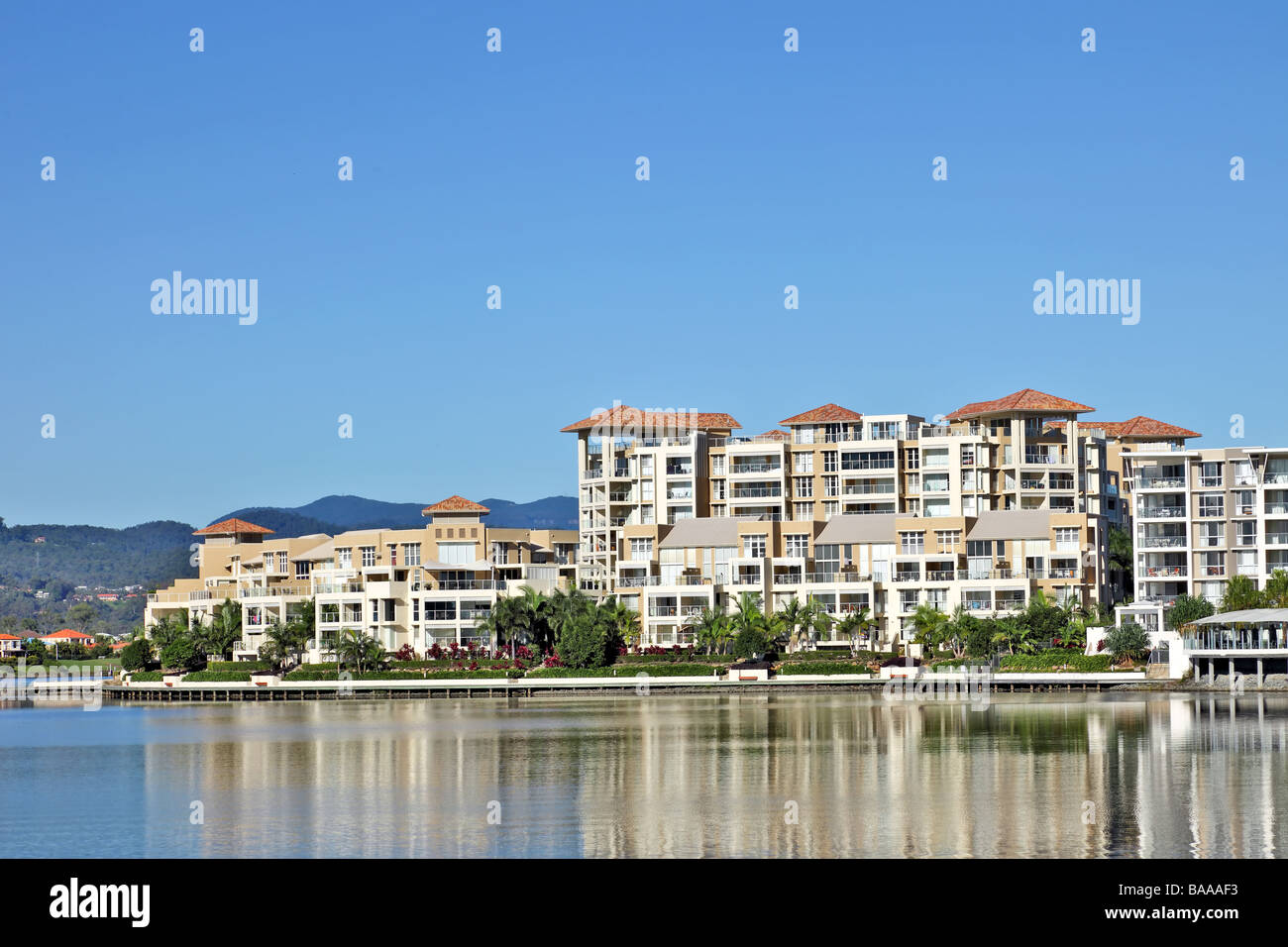 waterfront apartments on a lake showing reflection Stock Photo - Alamy