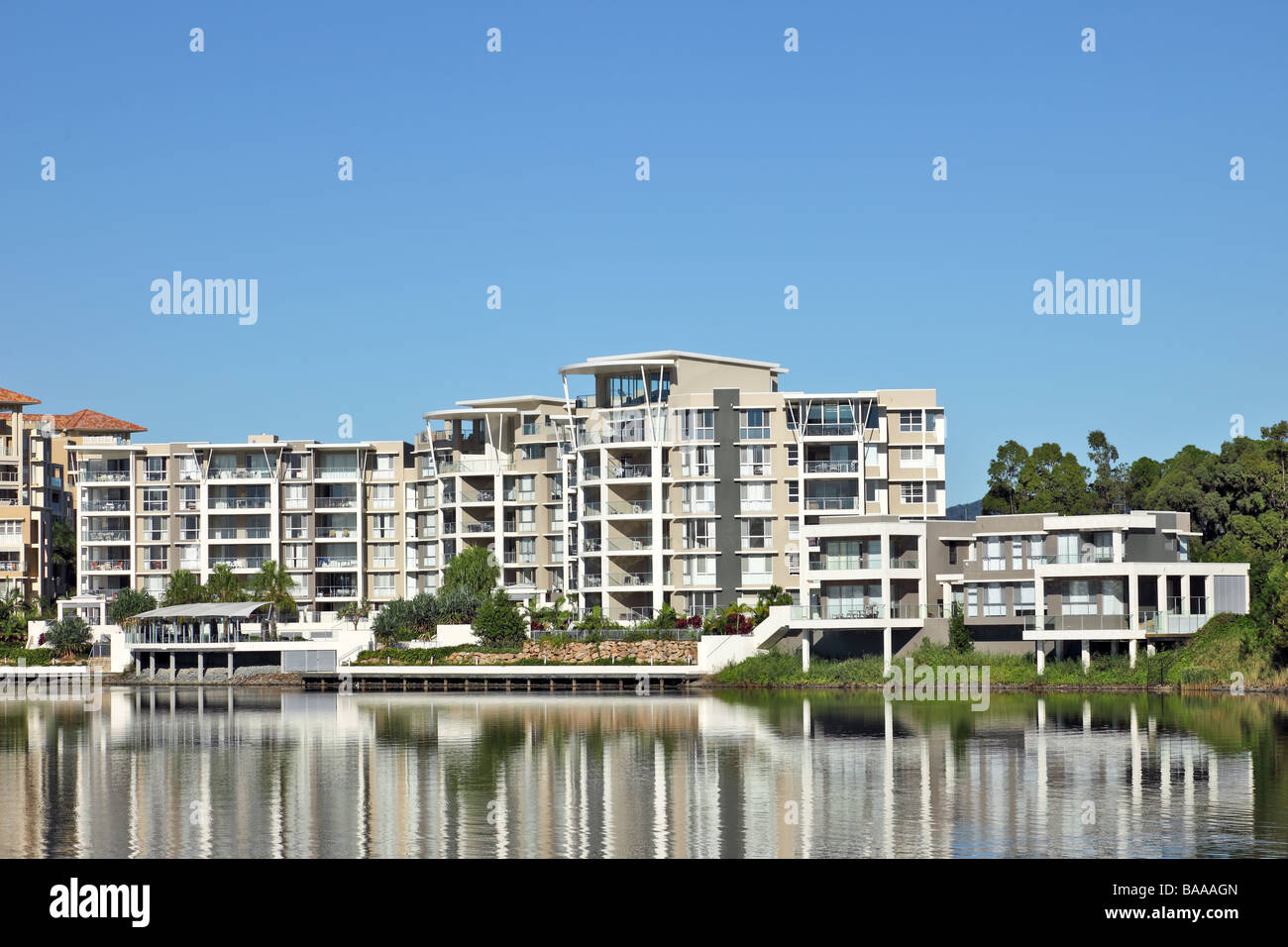 waterfront apartments on a lake showing reflection Stock Photo - Alamy