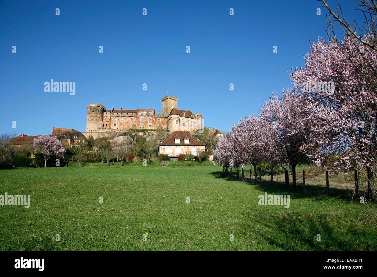 Castle and old village of Bretenoux in green fields France Stock Photo ...