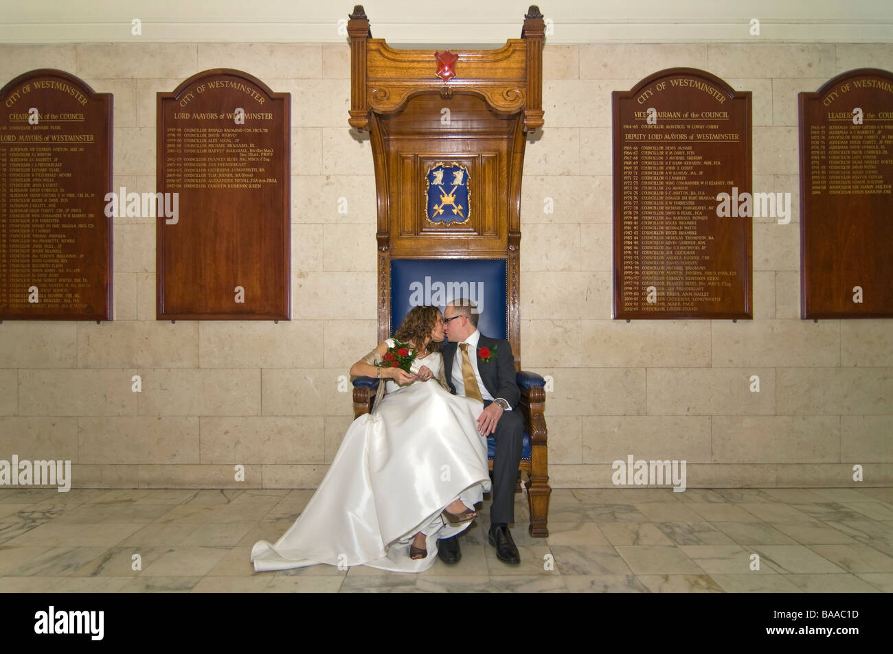 Horizontal wide angle portrait of newly wed bride and groom sitting ...