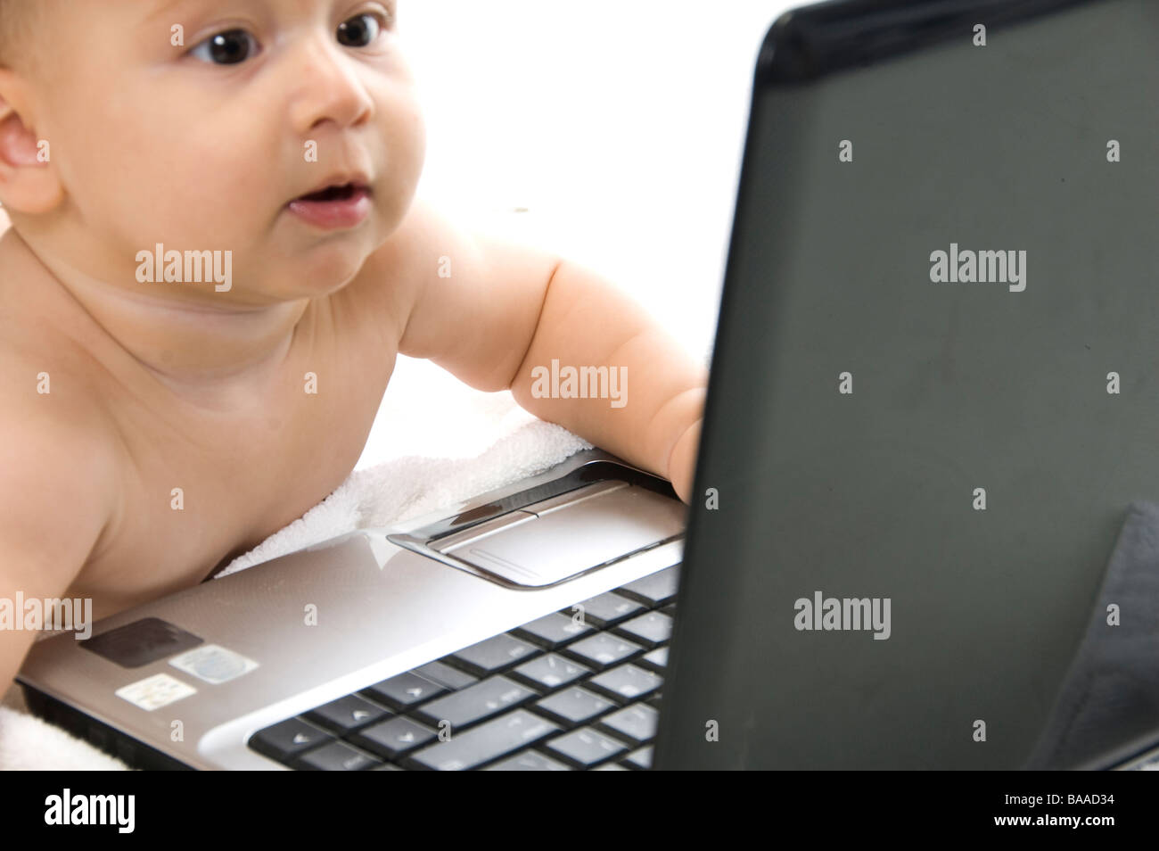 young child interested with laptop Stock Photo - Alamy
