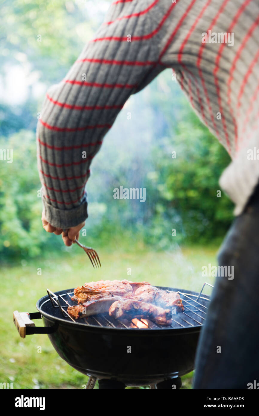 A man grilling meat, Sweden Stock Photo - Alamy