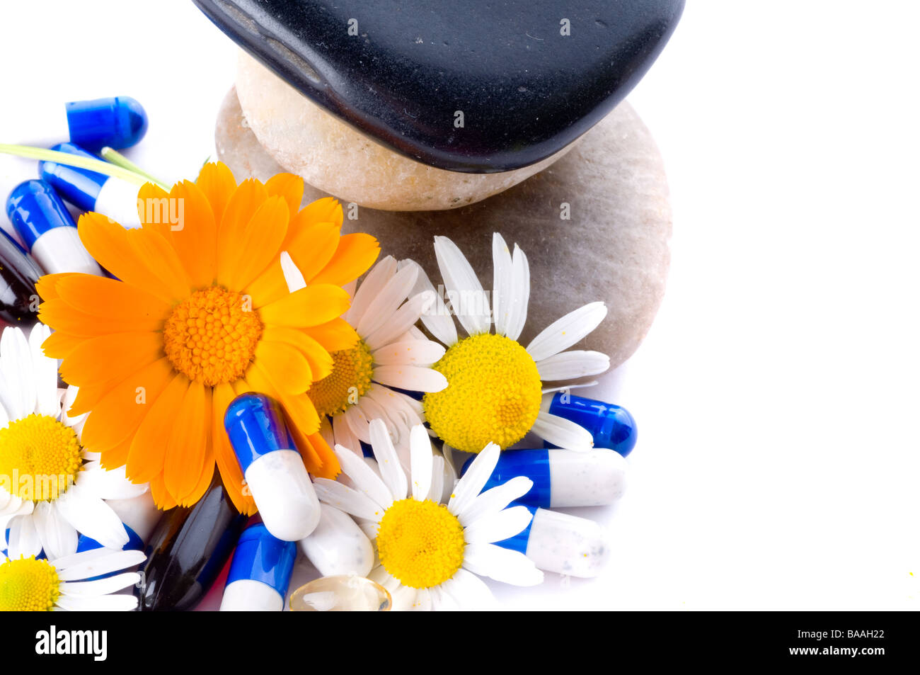 Tablets and flowers Herbal medicine Stock Photo - Alamy