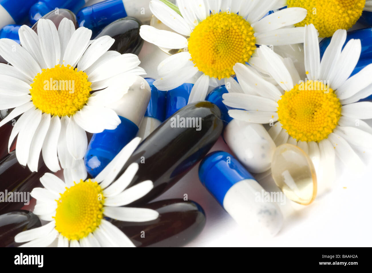 Tablets and flowers Herbal medicine Stock Photo - Alamy