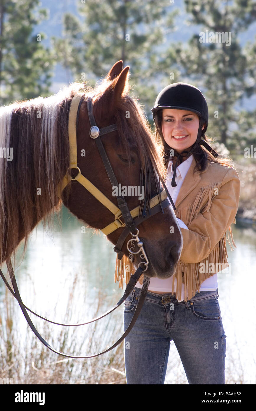 beautiful young model posing with her horse Stock Photo - Alamy