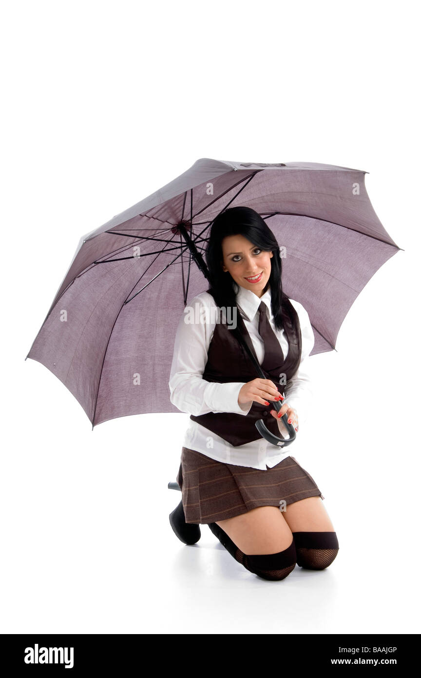 young female kneeling down on floor holding umbrella Stock Photo - Alamy