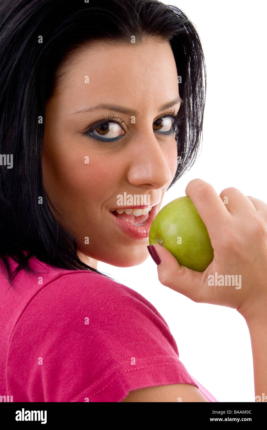 side pose of smiling female eating apple Stock Photo - Alamy