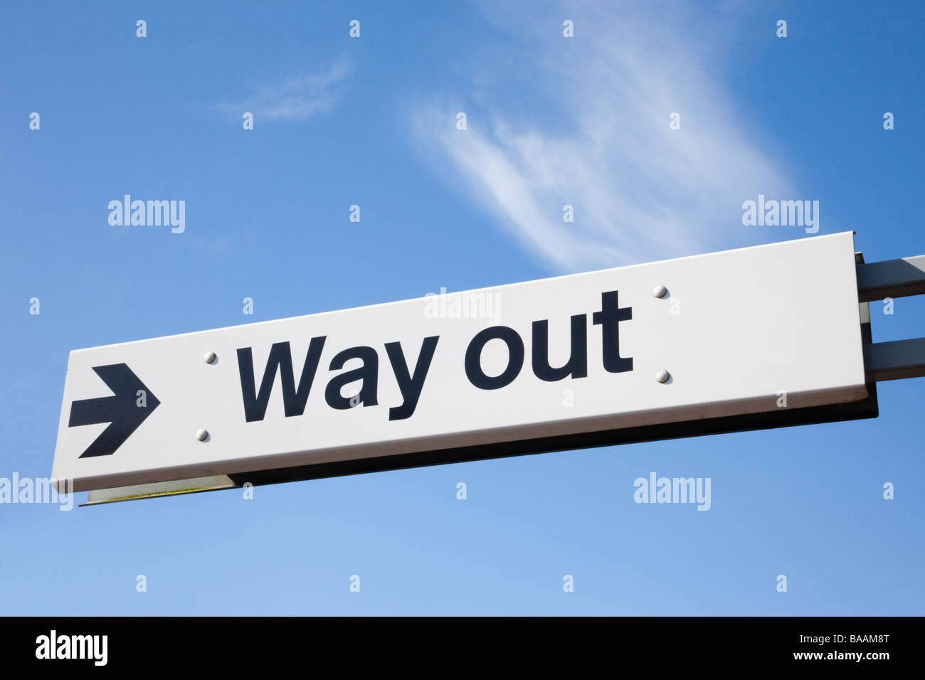Way Out sign with arrow against a blue sky in a station. England UK ...