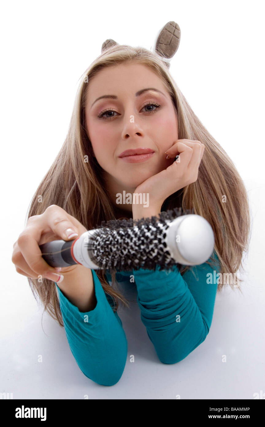 laying woman holding roller comb Stock Photo - Alamy